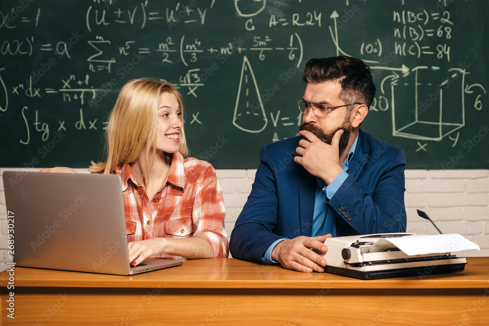 Teacher helping young student with lesson. Education and learning ...