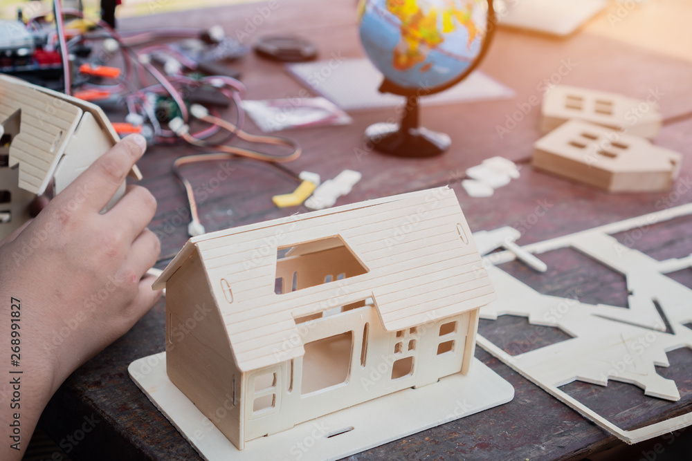 Construction building toy house or jigsaw home at outdoor near globe ...