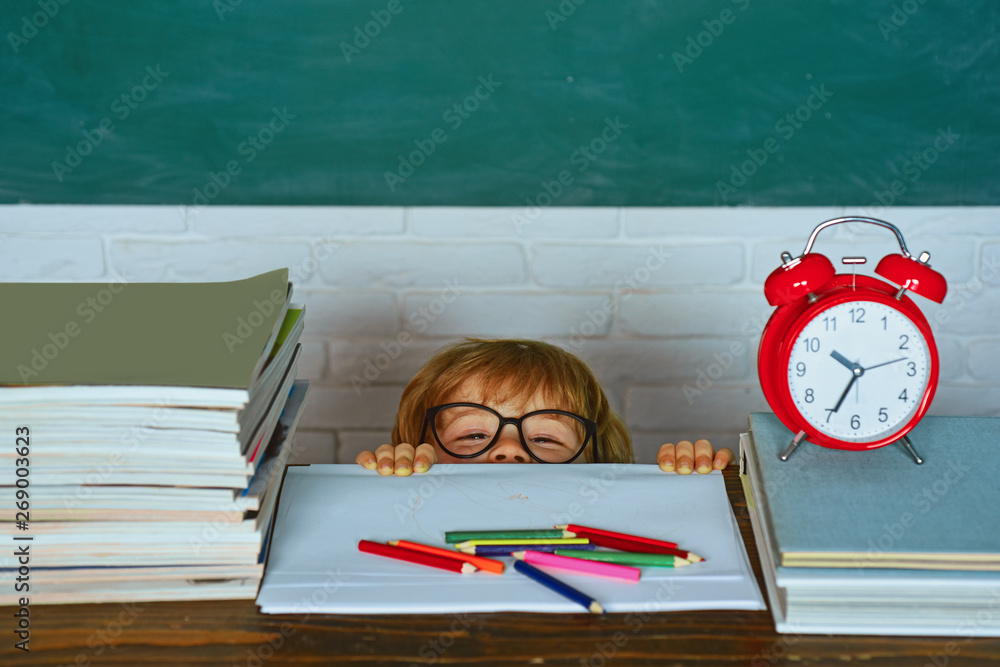 Time to learn concept. School kids against green chalkboard. Learning ...