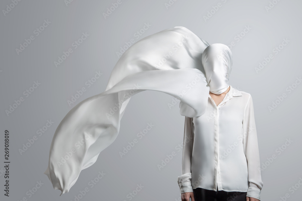 Anonymous model, covered with a white cloth. Woman in white shirt with ...