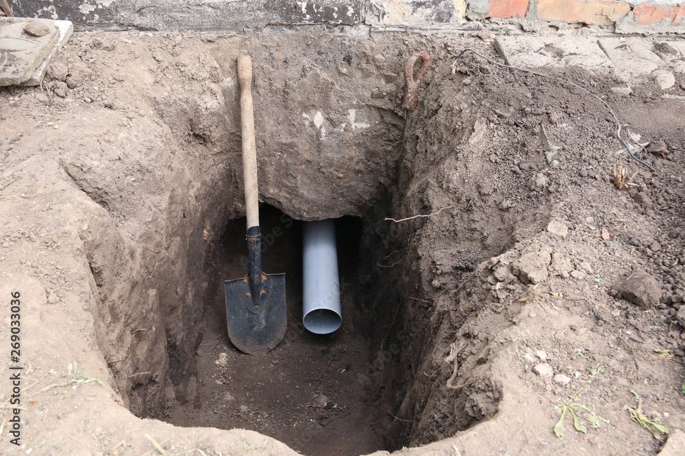 Deep pit and tunnel under the foundation of the house. Sewer pipe in a ...