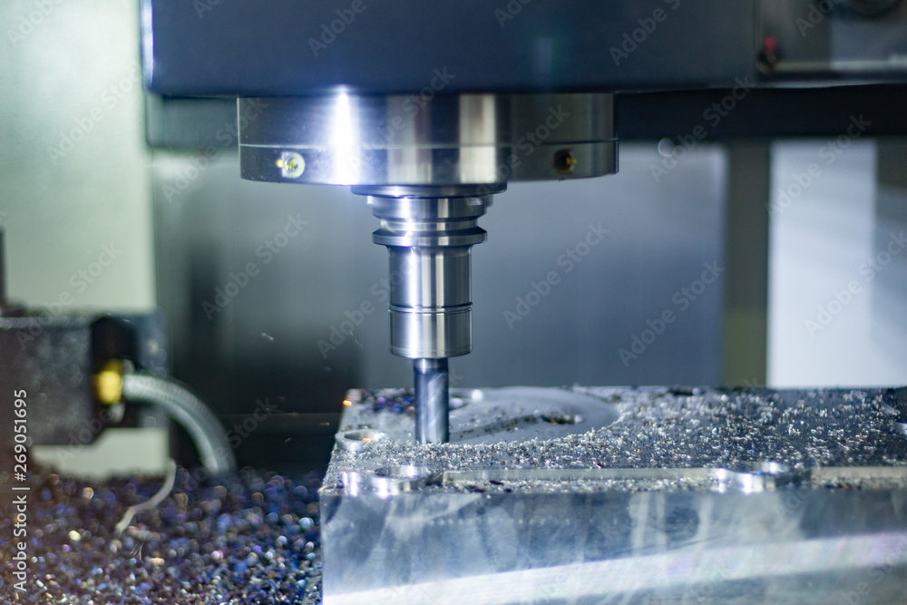 CNC milling machine during operation. Stock Photo | Adobe Stock