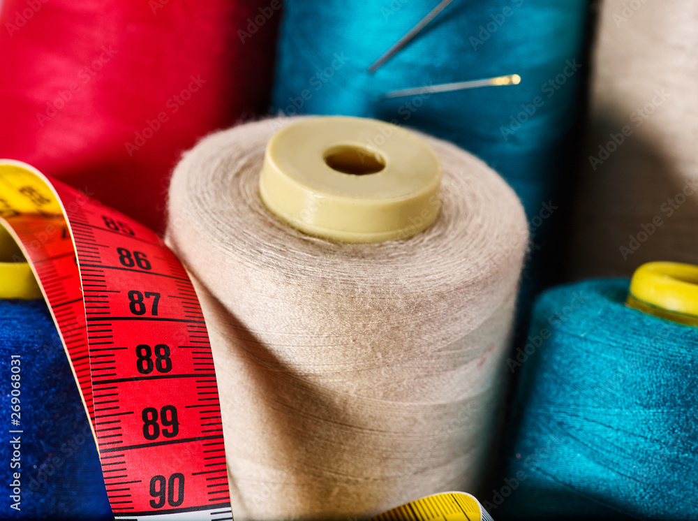 Coil Threads and measuring tape in mess sewing supplies close up. Stock ...