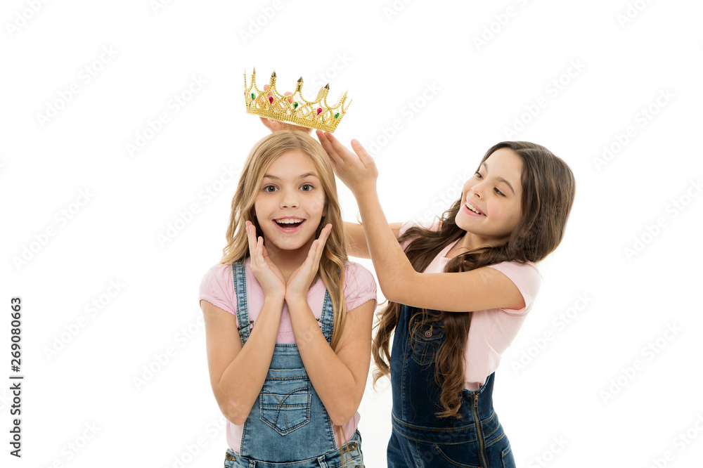 Rich reward. Little girl putting crown on head of small beauty queen ...
