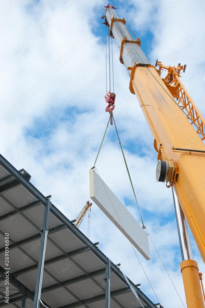 Installation of insulation panels on the construction of a new building ...