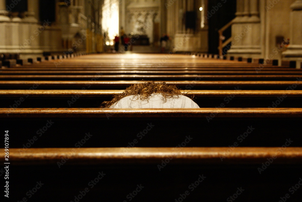 Catholic woman alone praying prostrate inside a Christian temple. Stock ...
