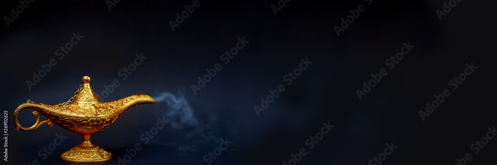 Magic lamp. A Vintage magical lamp and smoke coming out on the black ...