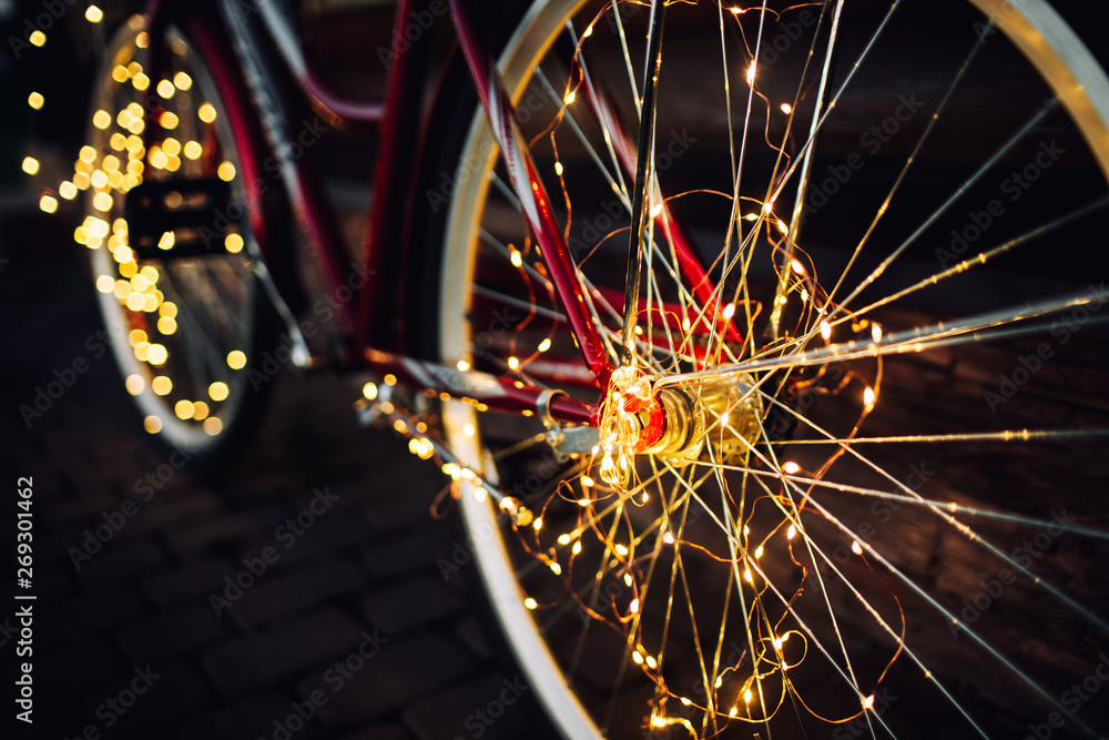 Christmas lights on bike background texture in city Photos | Adobe Stock