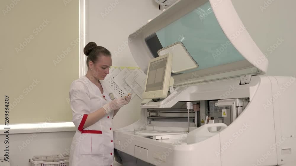 Young female researcher performing blood testing using professional ...