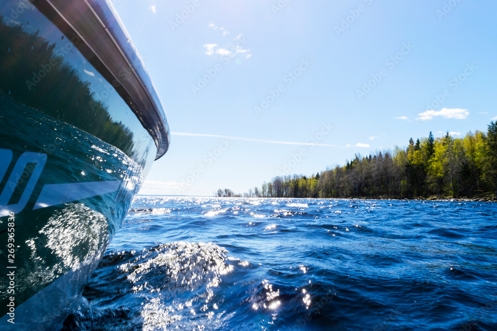 Side view Speeding fishing motor boat with drops of water. Blue ocean ...