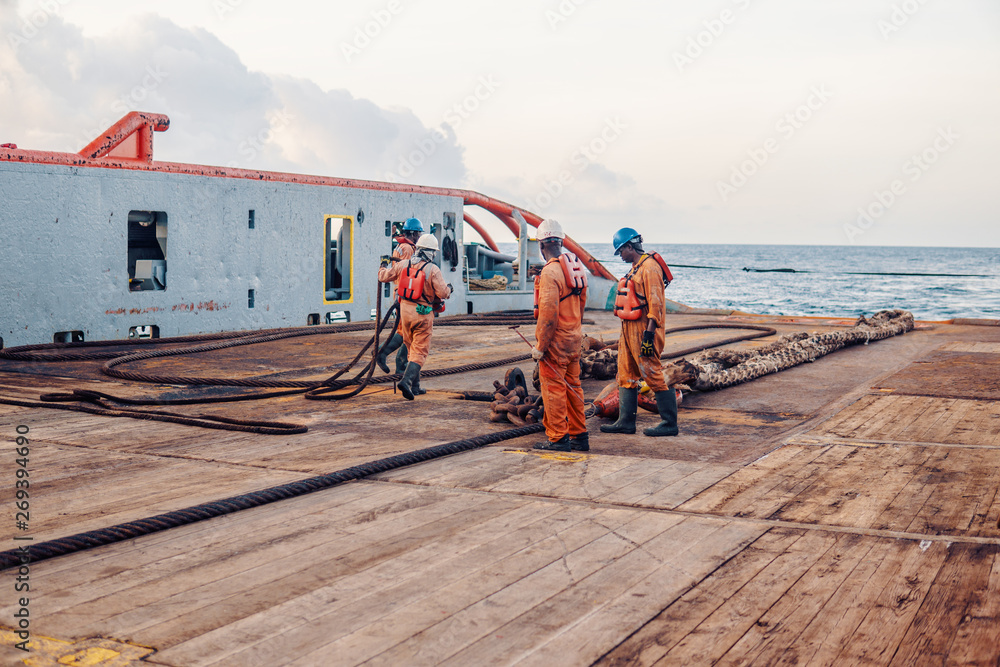 Anchor-handling Tug Supply AHTS vessel crew preparing vessel for static ...