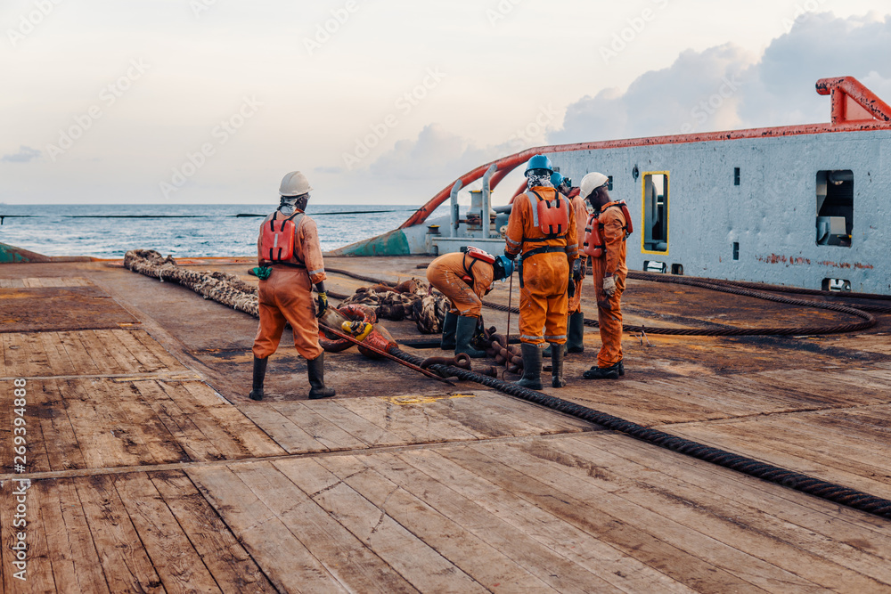 Anchor-handling Tug Supply AHTS vessel crew preparing vessel for static ...