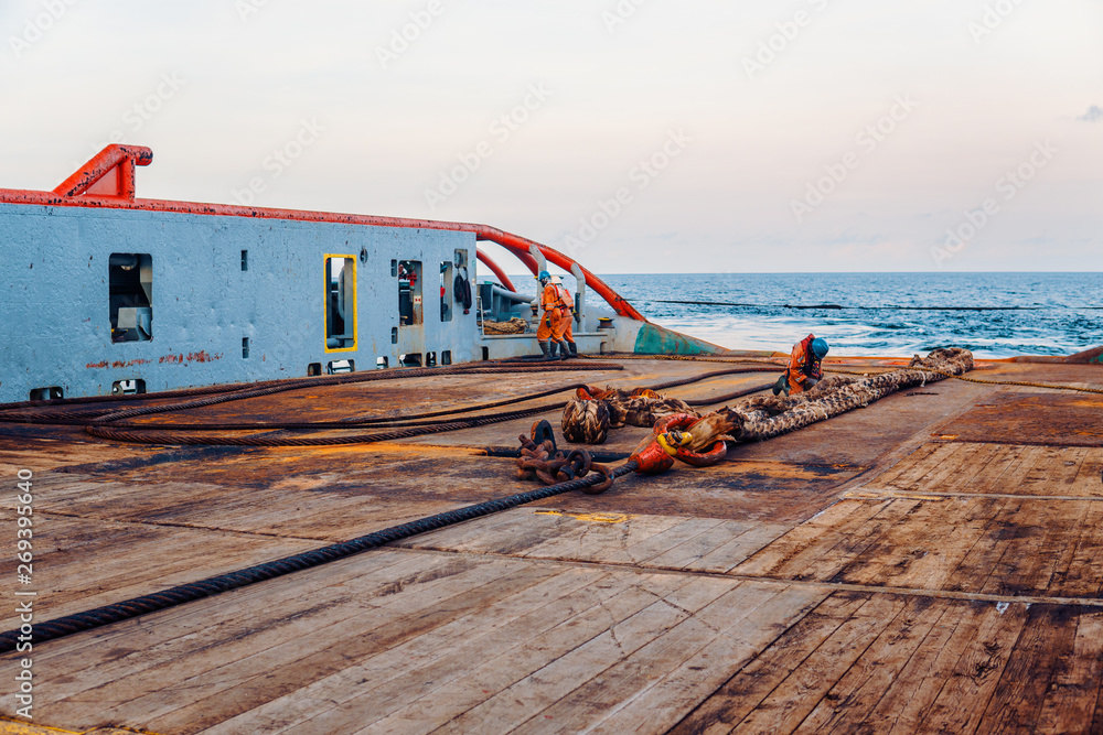 Anchor-handling Tug Supply AHTS vessel crew preparing vessel for static ...