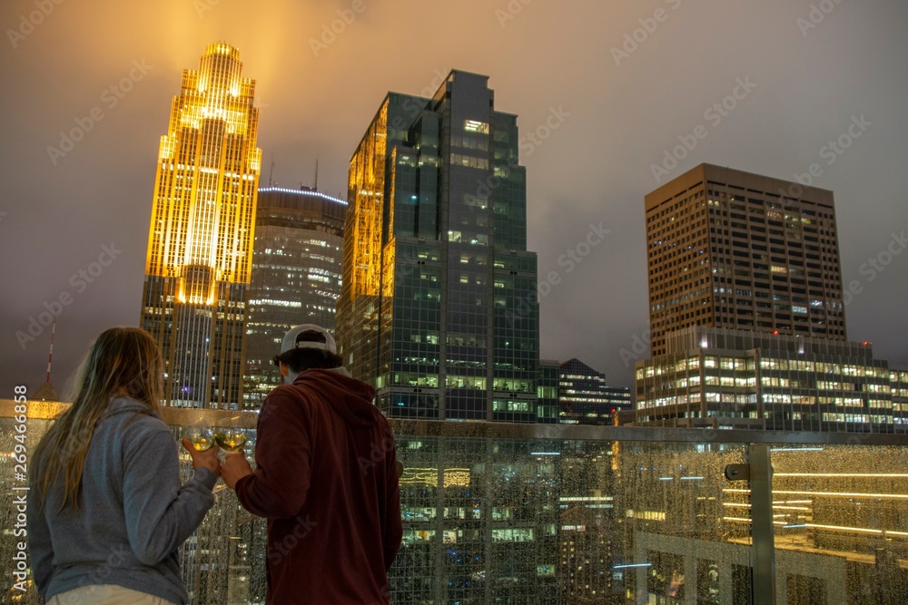 Young Couple relaxes and cooks on the rooftop Patio of a Downtown ...