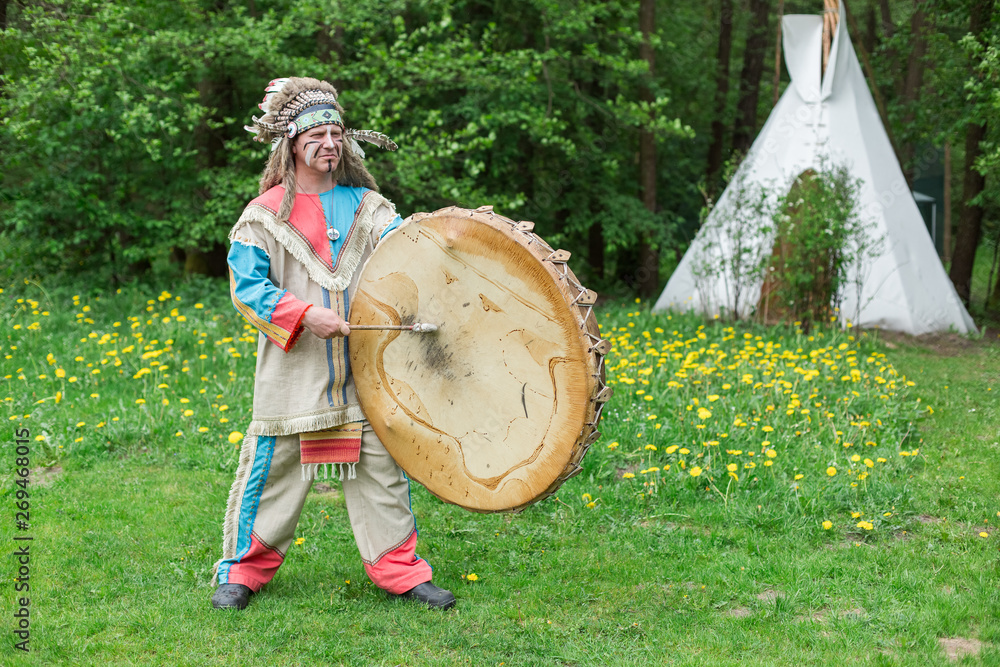 Native american indian, tribal leader in traditional indian clothes ...