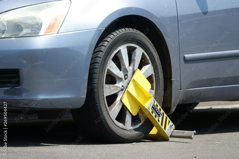 Modern Parking Boot with Keypad Clamped to a Car Wheel Stock Photo ...