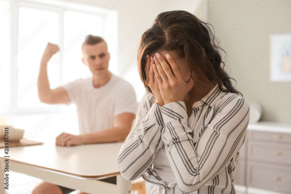 Aggressive husband threatening her crying wife at home Photos | Adobe Stock