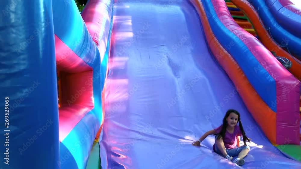 Child jumping on colorful playground trampoline. Kids jump in ...