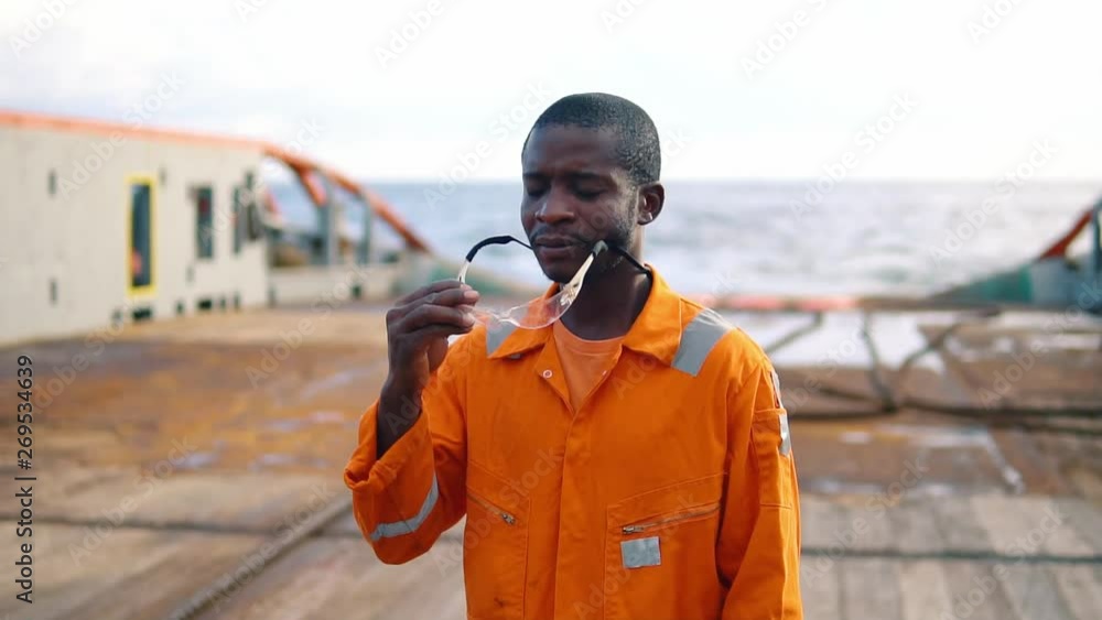 Vidéo Stock Tired Seaman AB or Bosun on deck of vessel or ship ...