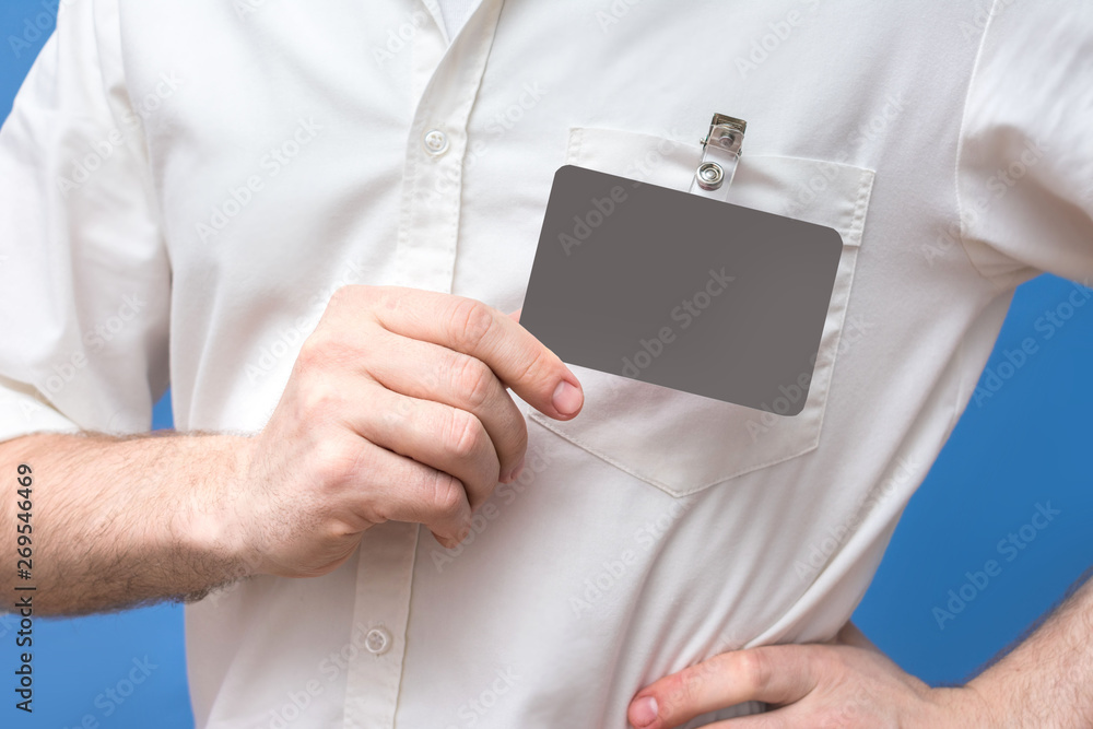 Man showing badge card, blue background, men's hand, badge, man in ...