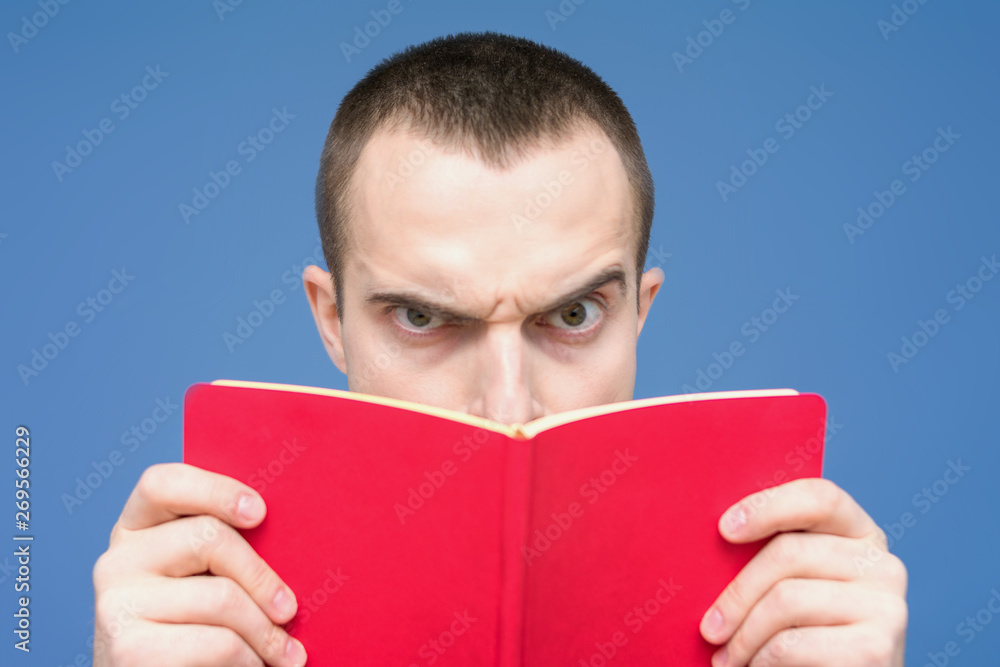 Man is angered after reading the book, facial expressions, close up ...