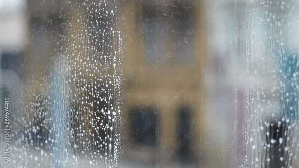 Cleaning windows vertically with a window sweeper squeegee and gloves ...