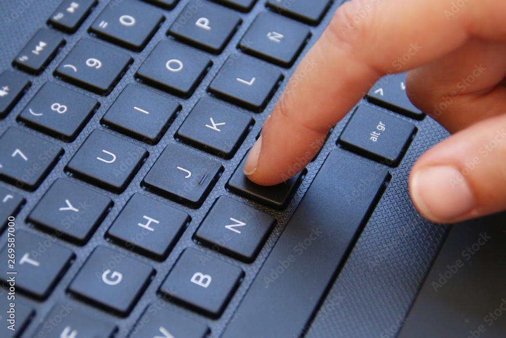 Using the laptop. Girl finger typing. Stock Photo | Adobe Stock