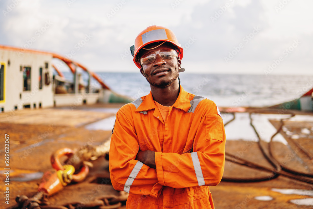 happy Seaman AB or Bosun on deck of vessel or ship , wearing PPE ...