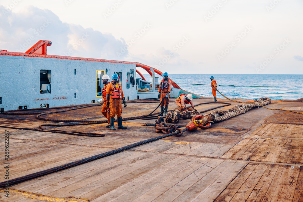 Anchor-handling Tug Supply AHTS vessel crew preparing vessel for static ...