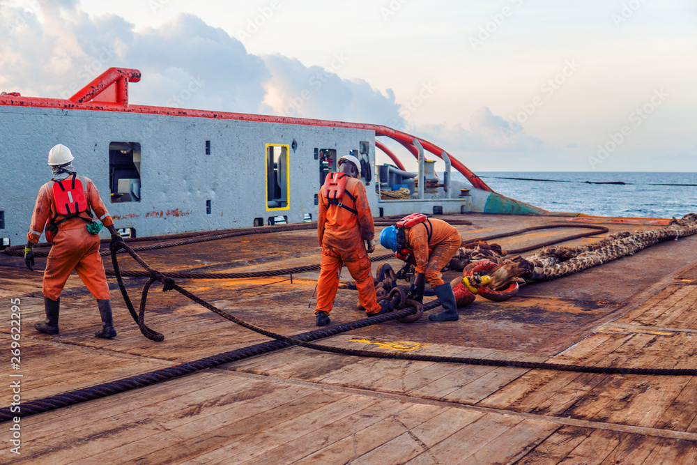 Anchor-handling Tug Supply AHTS vessel crew preparing vessel for static ...