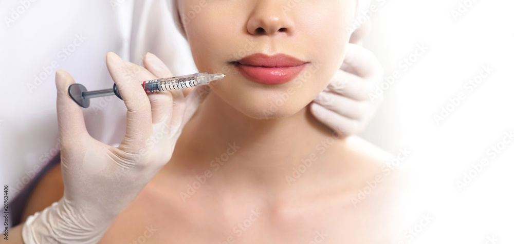 Lips injection close up. Syringe with filler for face contouring or ...