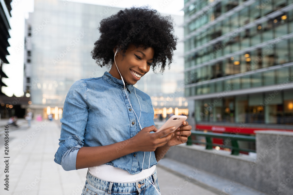 attractive dark skinned girl is listening to music chatting with ...