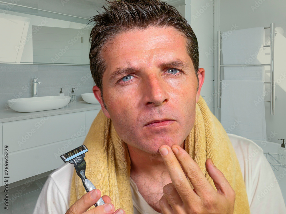 lifestyle home portrait of attractive and concentrated man holding ...