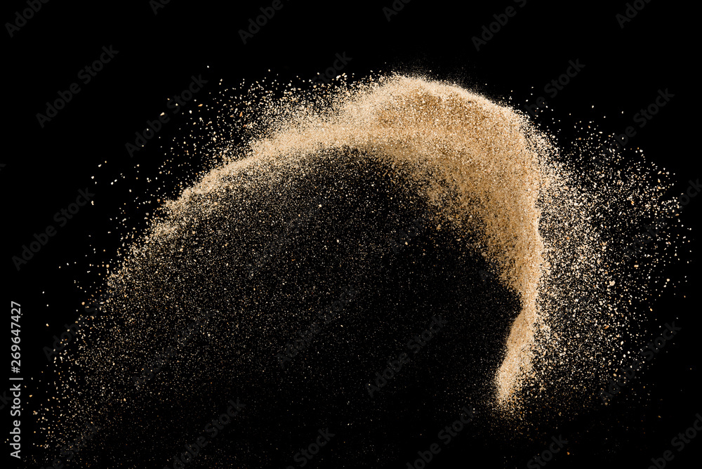Sand flying explosion on black background ,throwing freeze stop motion ...