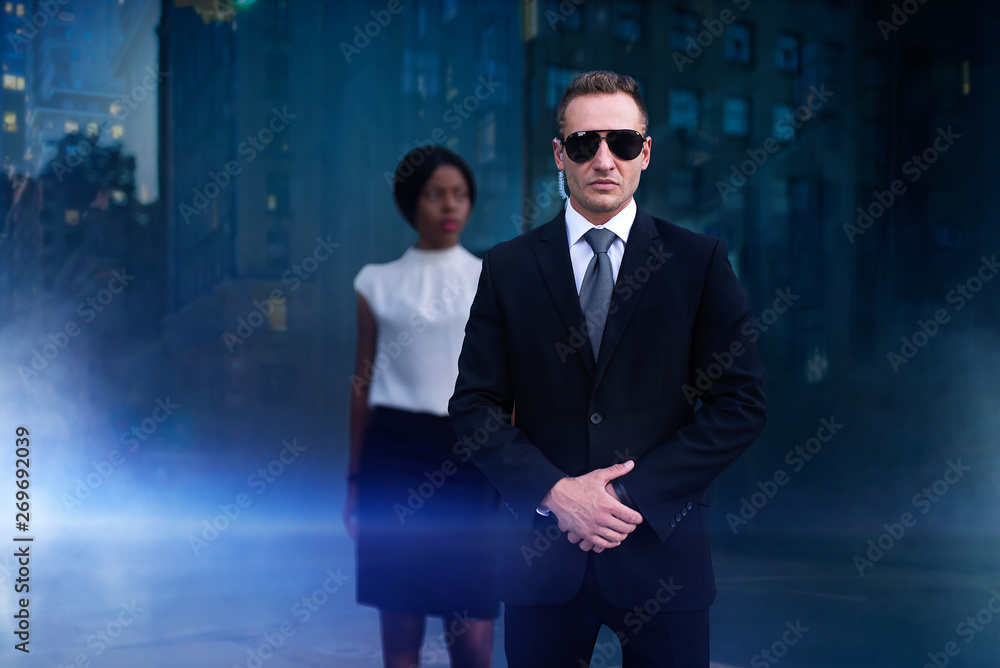Personal bodyguard of black business woman Stock Photo | Adobe Stock