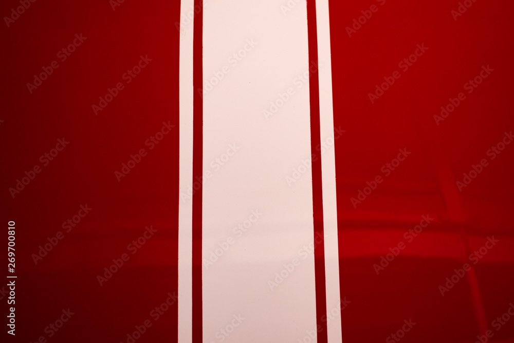 white racing stripes on red hood Stock Photo | Adobe Stock