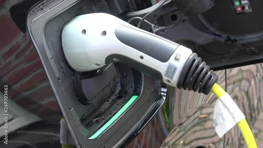 Video „Man pulling out the charge plug of an electric vehicle also ...