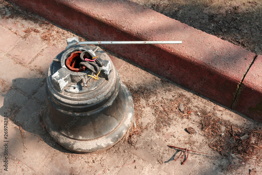 Base of broken lamp post on the grass in the public park. base of a ...