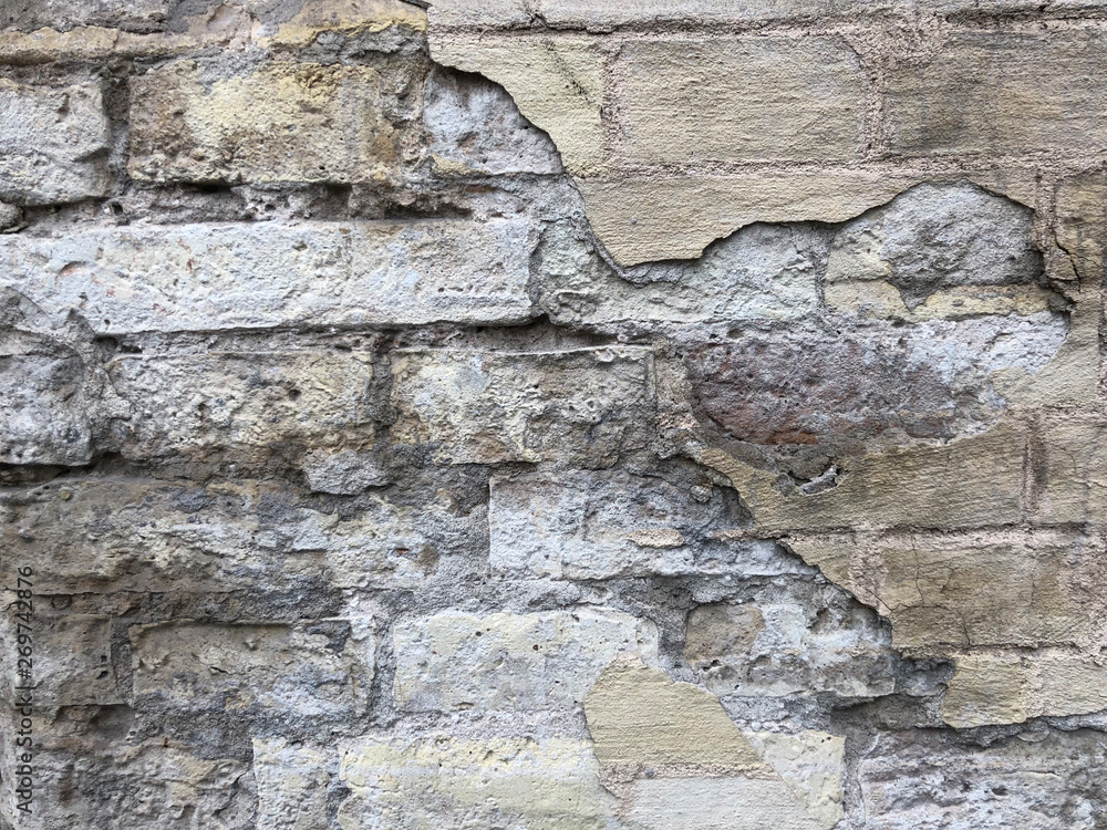 fallen plaster from a old yellow brick wall with lots of cracks. Stock ...