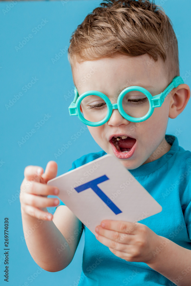 Cute little boy with letter on background. Child learn letters ...