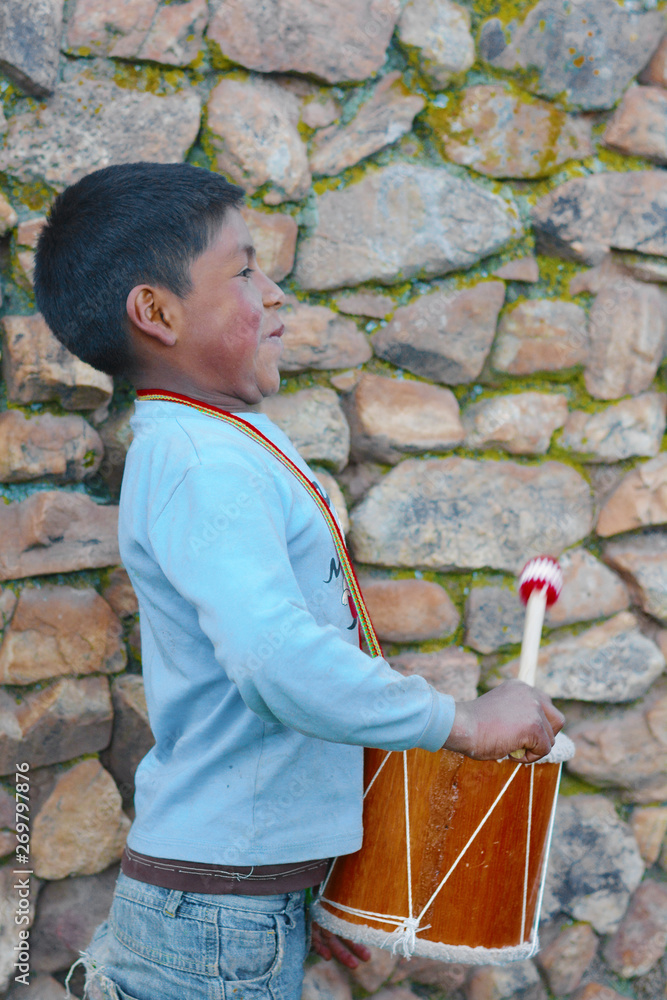 Little native american boy playing traditional sikuri drum. Stock Photo ...