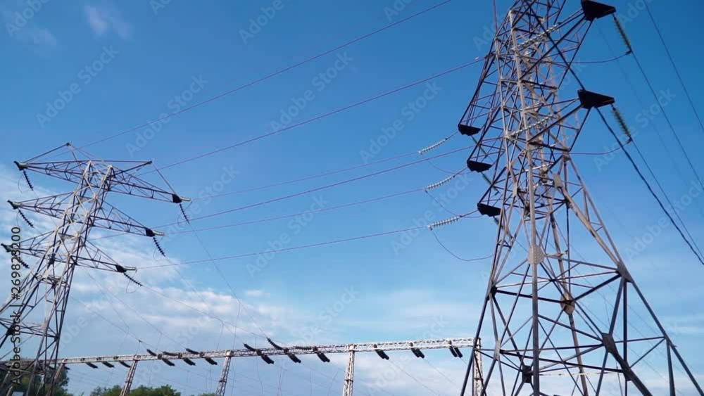 Electricity pylons. Moving along two row of pylons. electric high ...