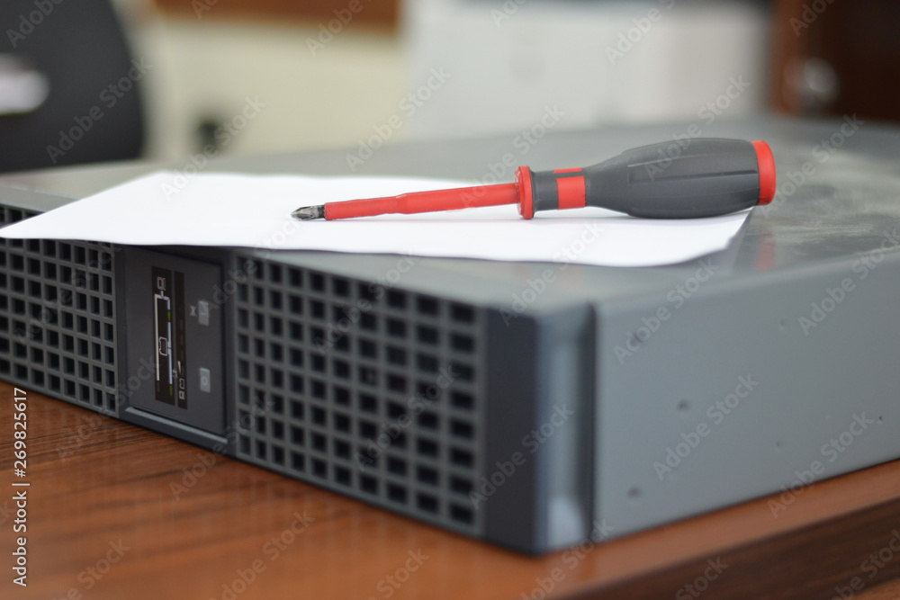 Damaged uninterruptible power supply laying on the table ready for ...
