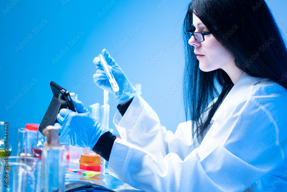 Laboratory cosmetics. Woman laboratory assistant examines a sample of ...