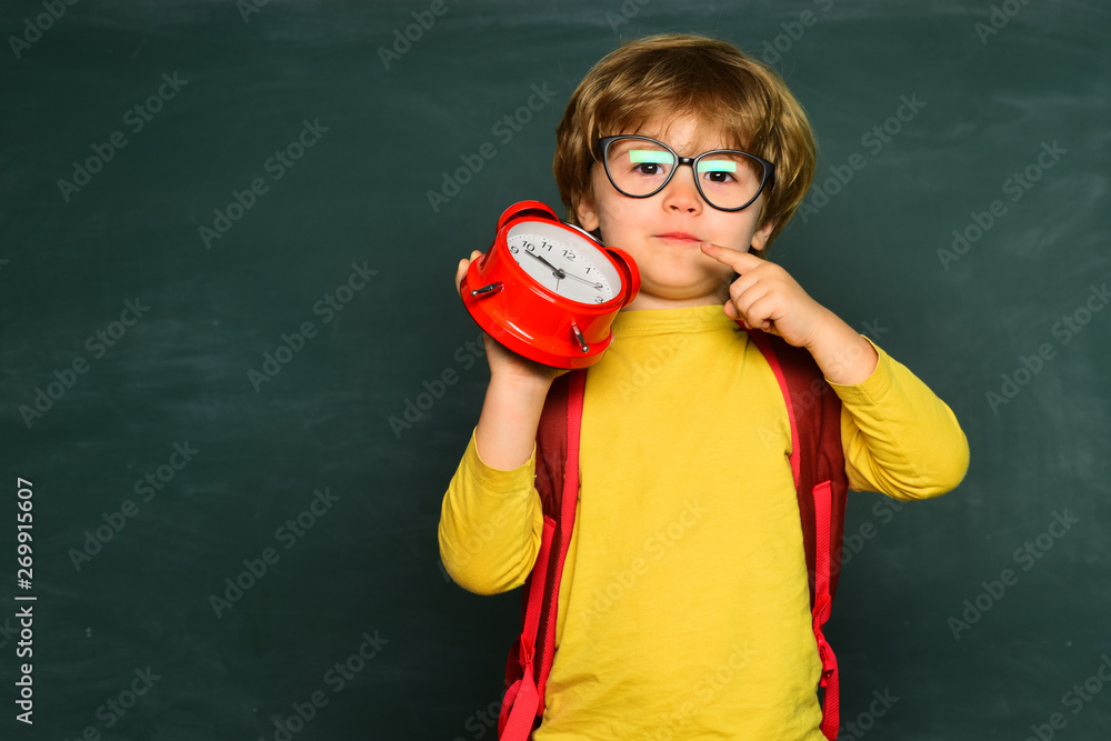 Fotka „Kids gets ready for school. Cute little boy turns off alarm ...