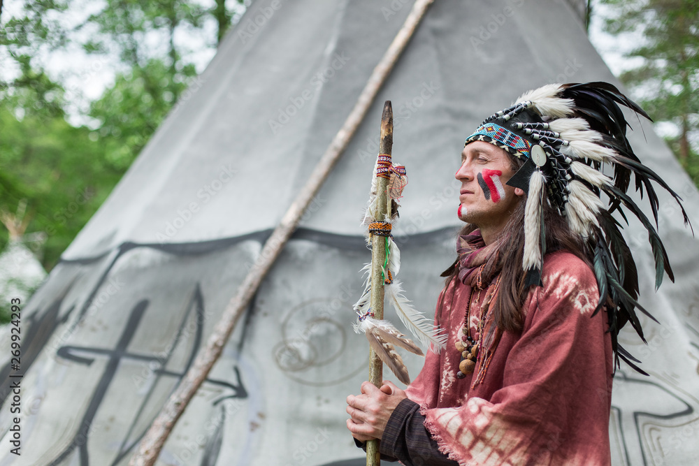 Native american indian, tribal leader in traditional indian clothes ...