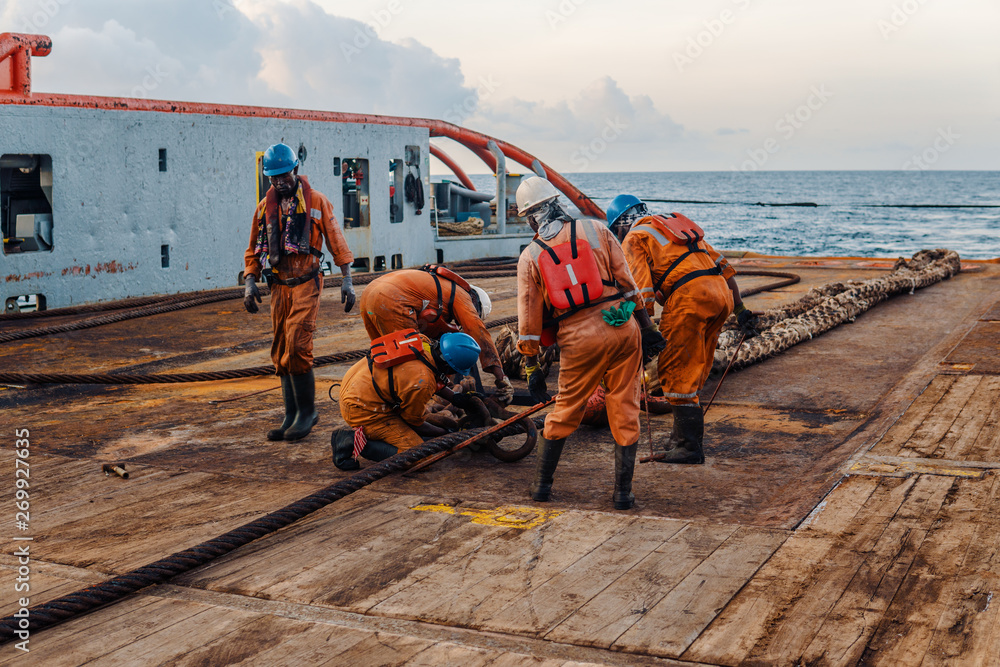 Anchor-handling Tug Supply AHTS vessel crew preparing vessel for static ...