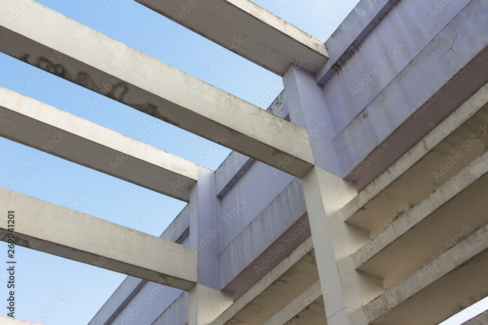 Looking up at the concrete pillars and beams at the top of modern high ...