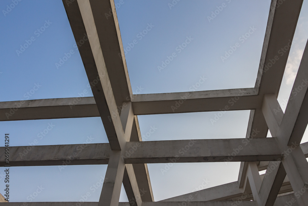 Looking up at the concrete pillars and beams at the top of modern high ...