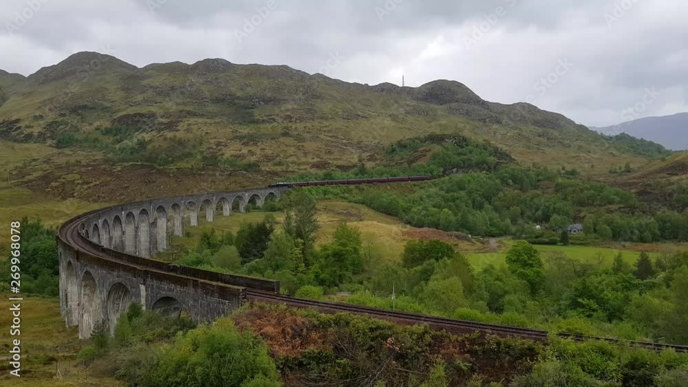 Steam train on famous Glenfinnan viaduct driving towards camera. Herry ...
